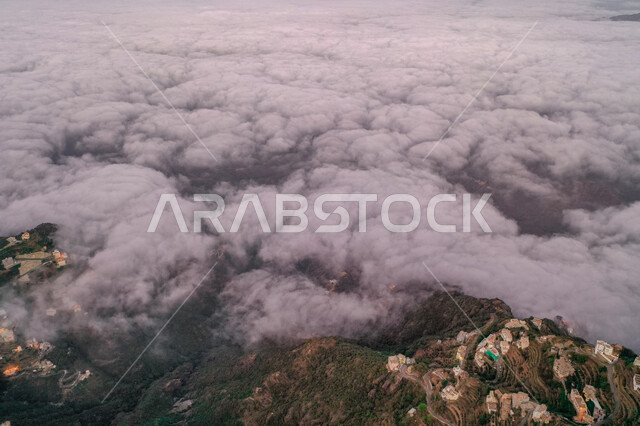 Aerial photograph of fog in the Fifa Mountains region in Jizan, houses ...