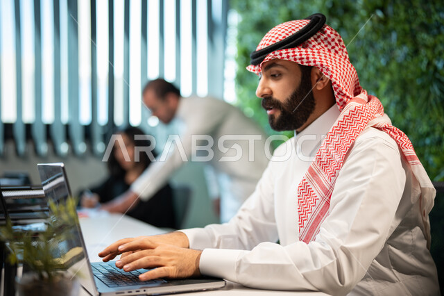 Communicating with customers through a laptop, a Saudi Arabian Gulf ...