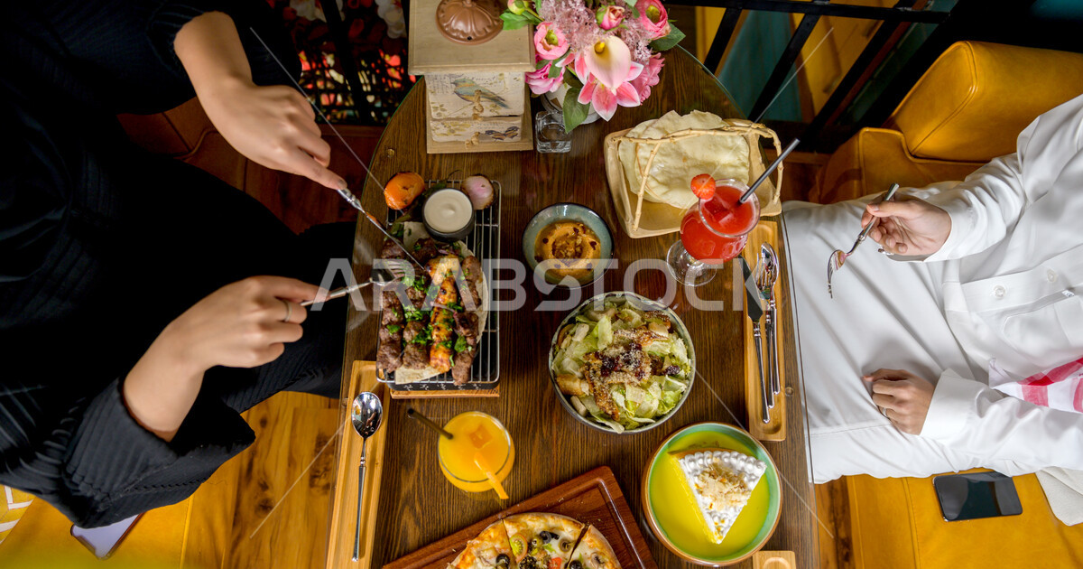 A picture from above of a dining table for a Saudi Arabian Gulf couple ...