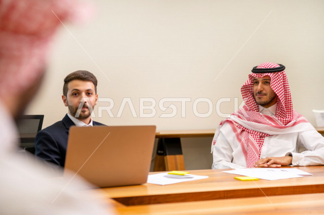 A Saudi Arabian Gulf businessman in traditional Saudi dress, with his ...