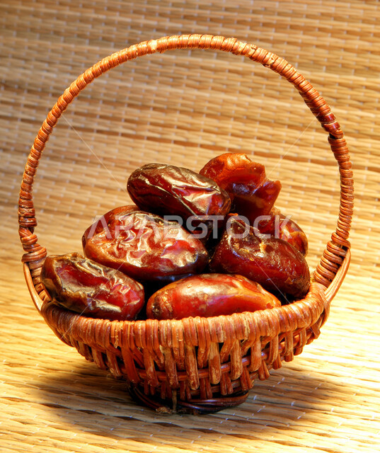 Healthy dates in a wooden basket, Ramadan hospitality, a meal with ...