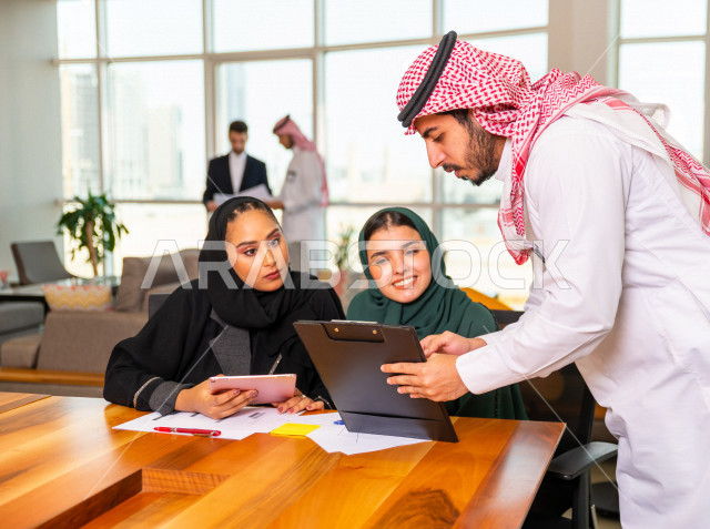Two Saudi women businessmen in the Gulf in the meeting room inside the ...