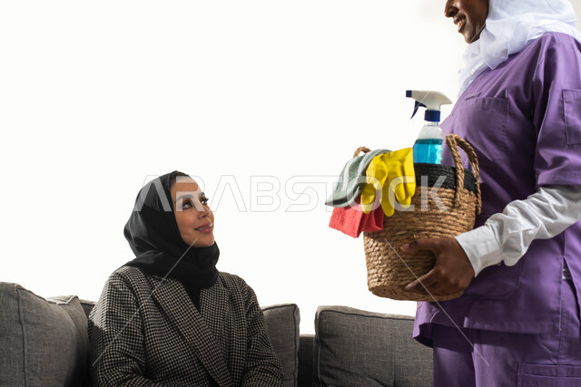 Maids in Saudi homes, a close-up portrait from the side of a foreign ...
