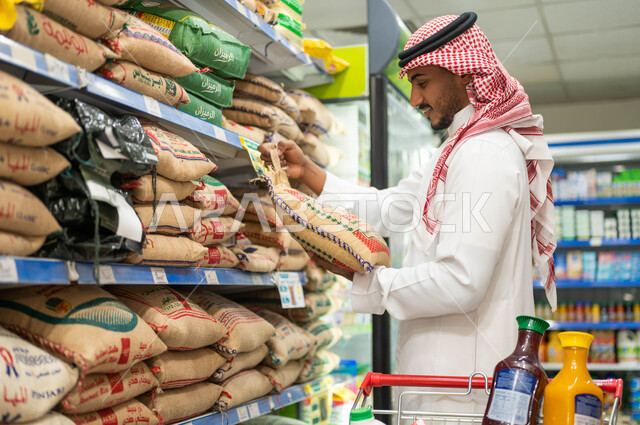 A group of bags of rice on the shelves inside the supermarket, a ...