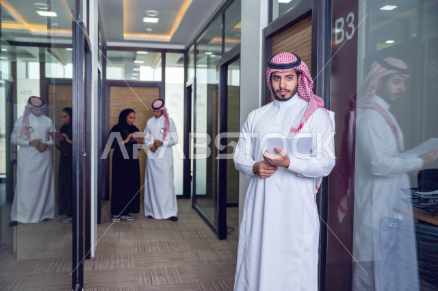 A Saudi Arabian Gulf man in traditional dress inside the company's ...