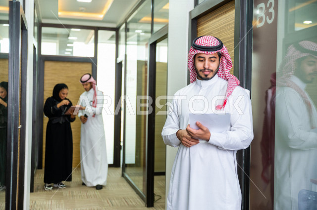 A Saudi Arabian Gulf man in traditional dress inside the company's ...