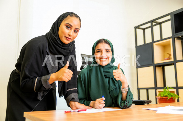 A Saudi Gulf business woman in the work office with the secretary ...
