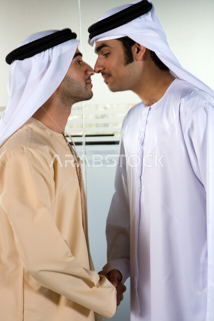 Handshake between friends and colleagues in the Emirati work ...