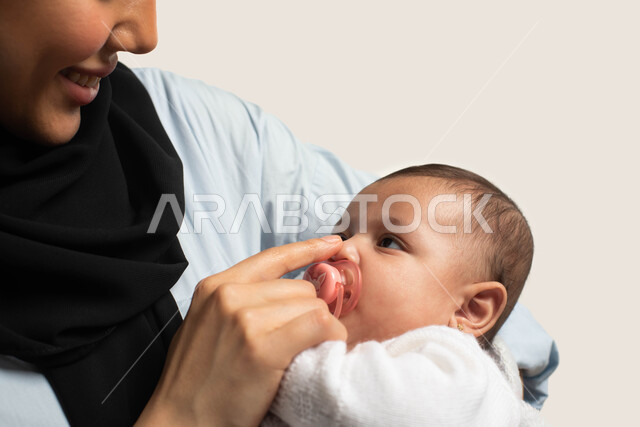 Looking at the little girl with gestures of tenderness and love, a ...