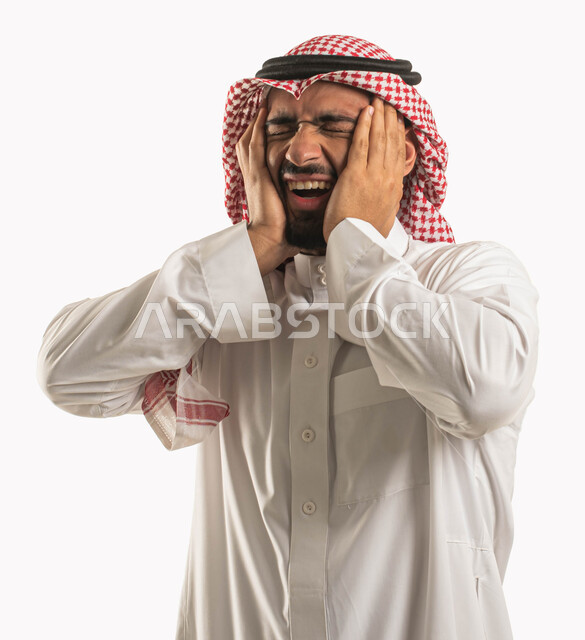 Feeling severe pain in the head, portrait of a Saudi Gulf Arab man ...