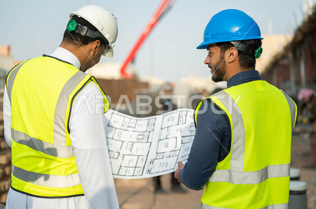 Working in the engineering field, standing at the construction site ...