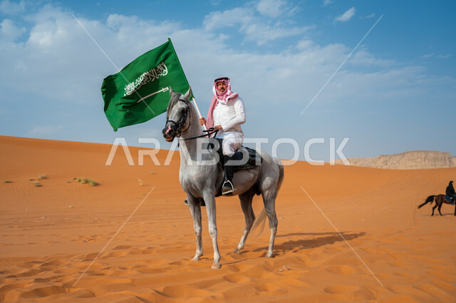 Promoting the concept of national unity, a Saudi Gulf Arab man riding a ...