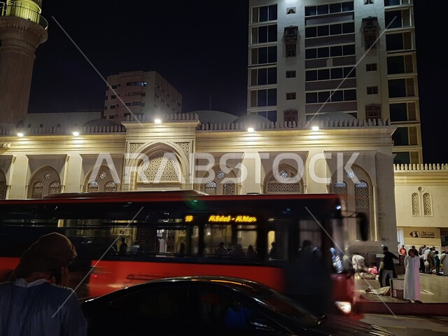 Al Mahmal Mosque illuminated at night, car traffic on the roads and ...