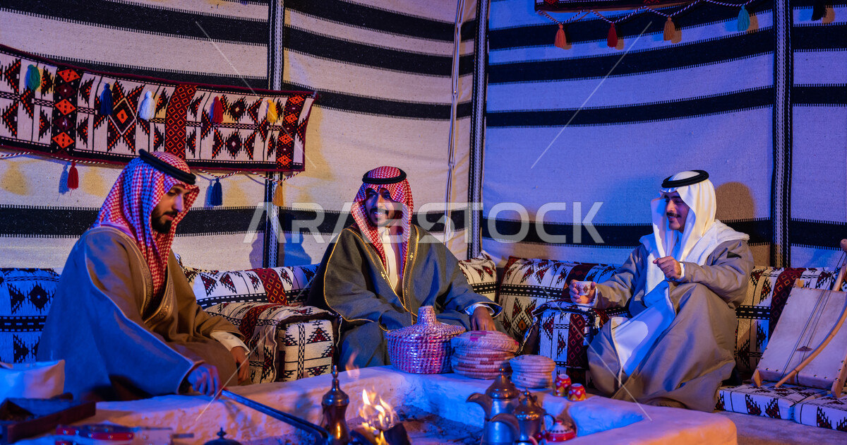 Saudi Gulf Arab friends wearing national costumes exchange ...