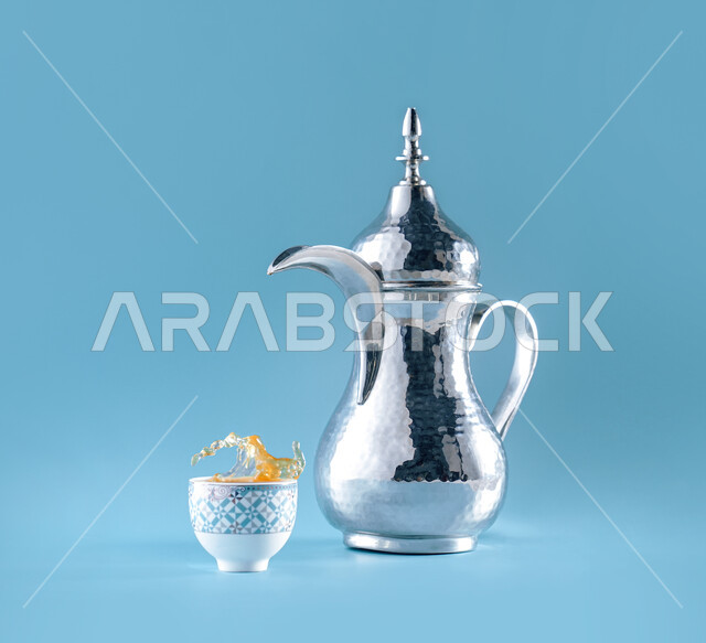 Arabic coffee dallah with a glass cup, enjoying serving hot drinks ...