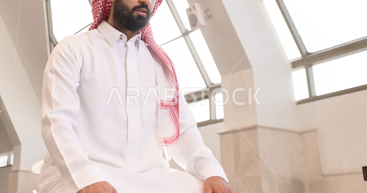Performing the obligatory prayer inside the mosque, a Saudi man prays ...
