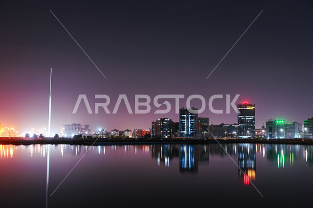 Reflection of the shapes and lights of the towers of Jeddah on the Red ...