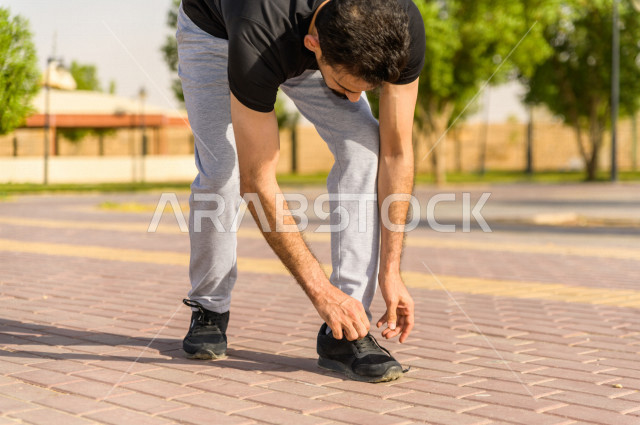 A young Saudi Gulf man practicing outdoor morning sports, walking ...
