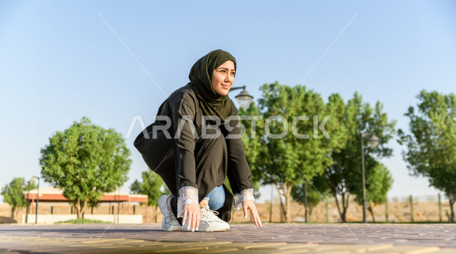 A young Saudi Arabian girl practicing outdoor morning sports, walking ...