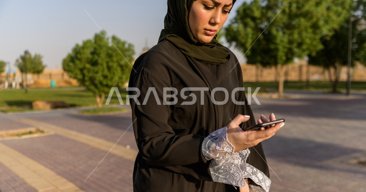 A young Saudi Arabian girl practicing outdoor morning sports, using her ...