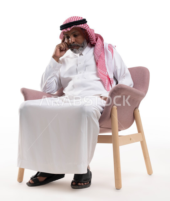 Solving problems and making decisions, portrait of an elderly Saudi ...