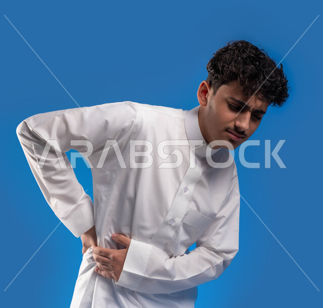 Feeling pain in the spine, a close-up portrait of a Saudi Gulf Arab ...