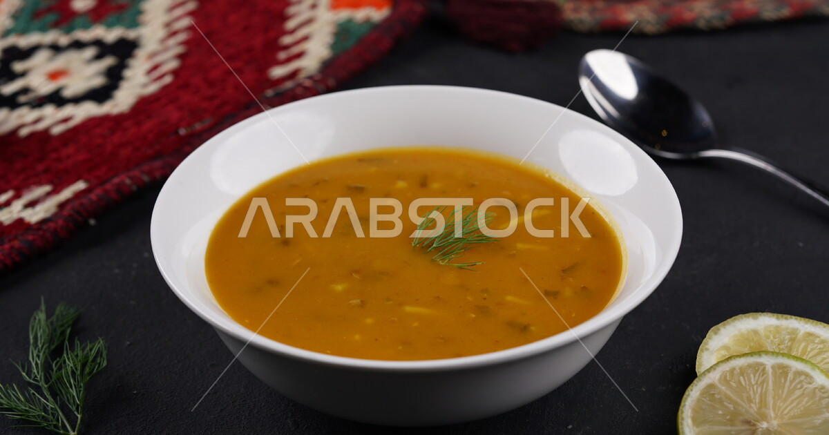 A close-up photo of a plate of delicious lentil soup, hot Arabic dishes ...