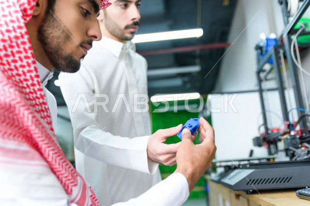 Two young Saudi innovators use a 3D printer to manufacture a product ...