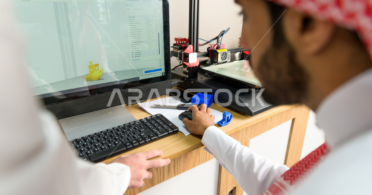 Two innovative young Saudis discuss research matters using computers ...