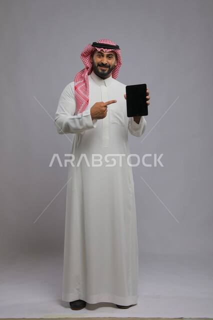 Standing straight and pointing at the tablet with a blank black screen ...