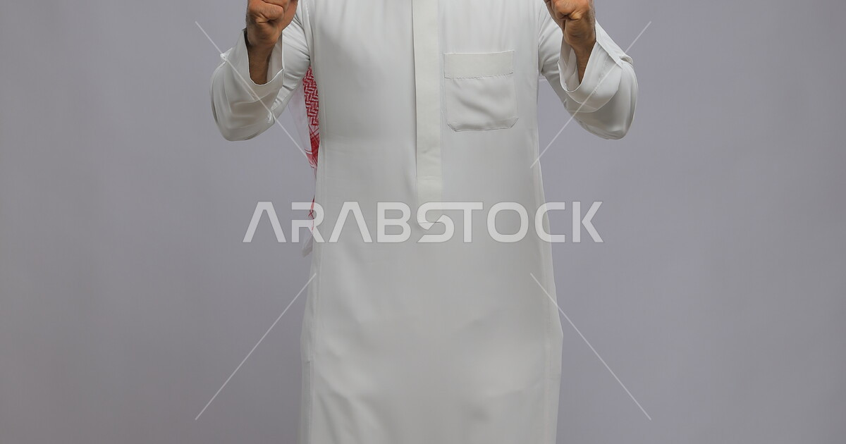 Gestures of victory and victory, portrait of a smiling Saudi Gulf Arab ...