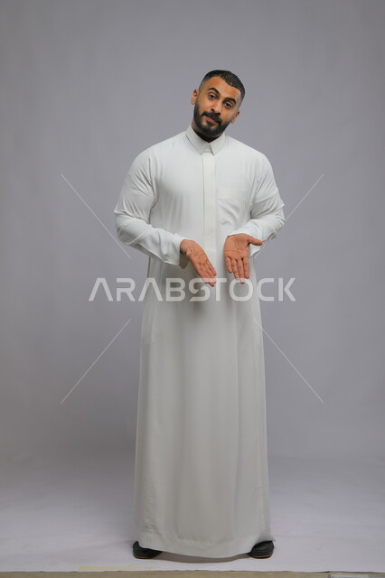 Gestures indicating a specific location, portrait of a smiling Saudi ...