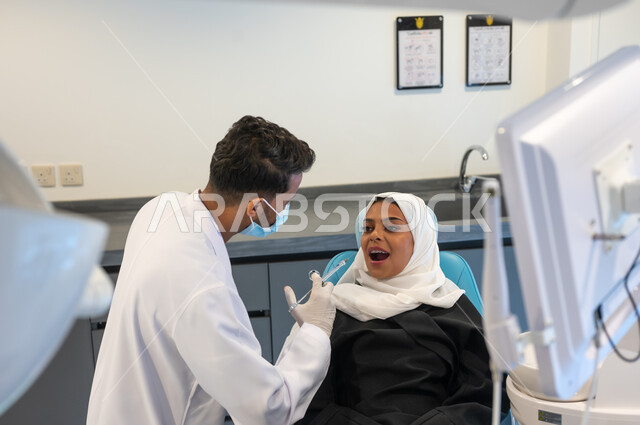 Local anesthetic injections to relieve pain, tooth restoration with ...