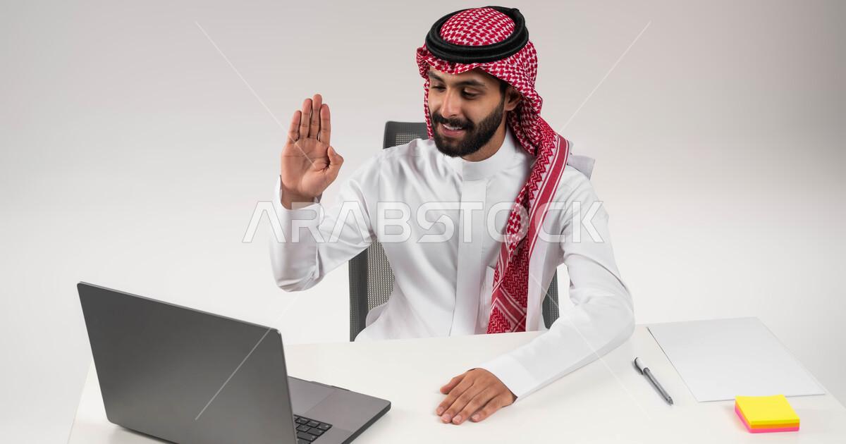 Waving a hand and saying hello from a distance, a close-up portrait of ...