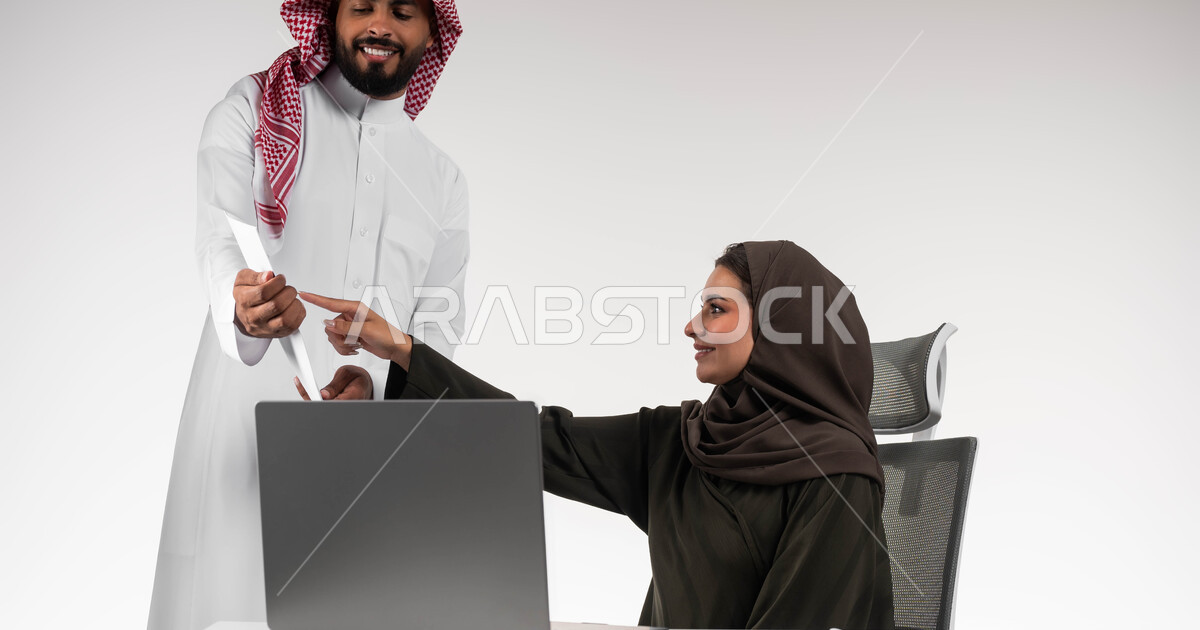 Teamwork and team spirit, a portrait of two Saudi Gulf Arab colleagues ...