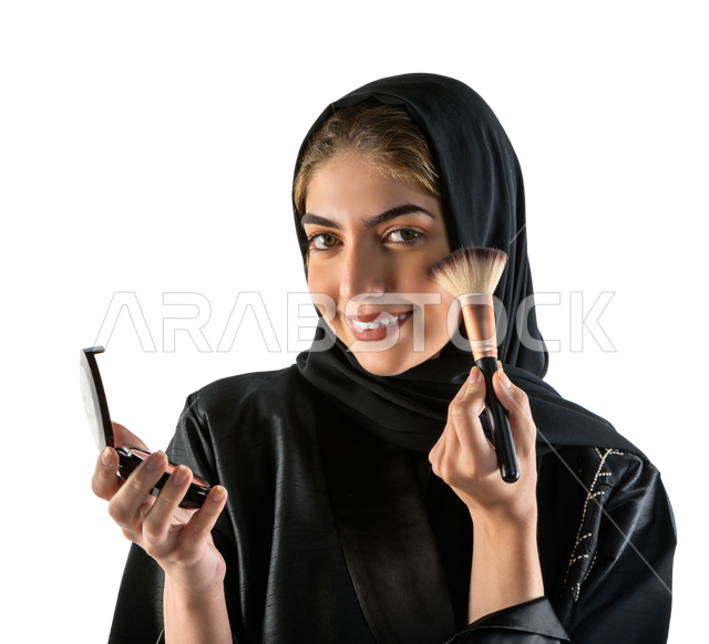 Portrait of a happy Saudi Arabian Gulf woman, who uses a set of ...