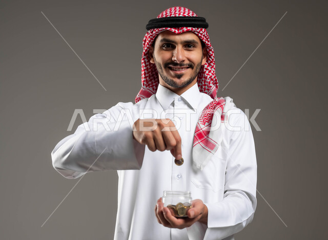 Managing accounts and paying bills, coins and paper money for the Saudi ...