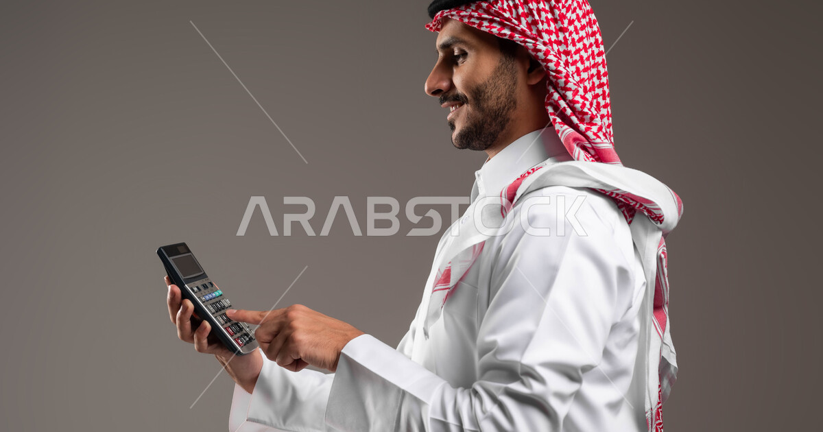 Working in accounting management, a side portrait of a Saudi Gulf Arab ...