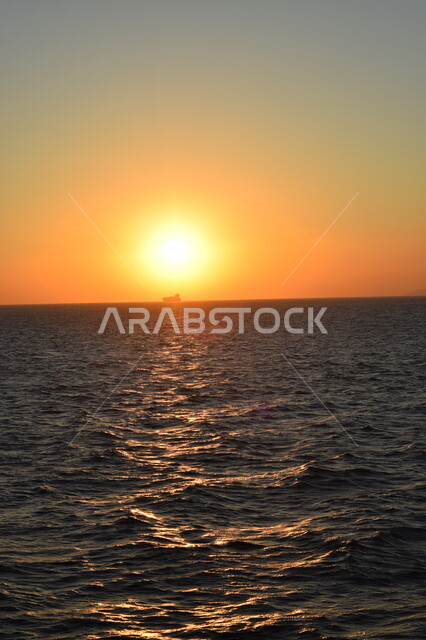 A view of the reflection of the sunset over the sea surface in the ...