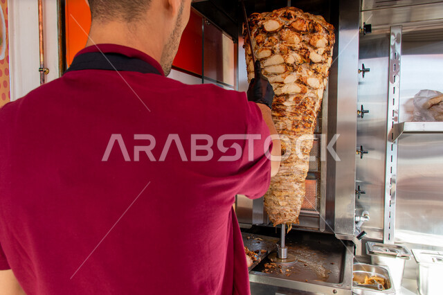 Delicious fast food meals, doner kebab and chicken rotating vertically ...