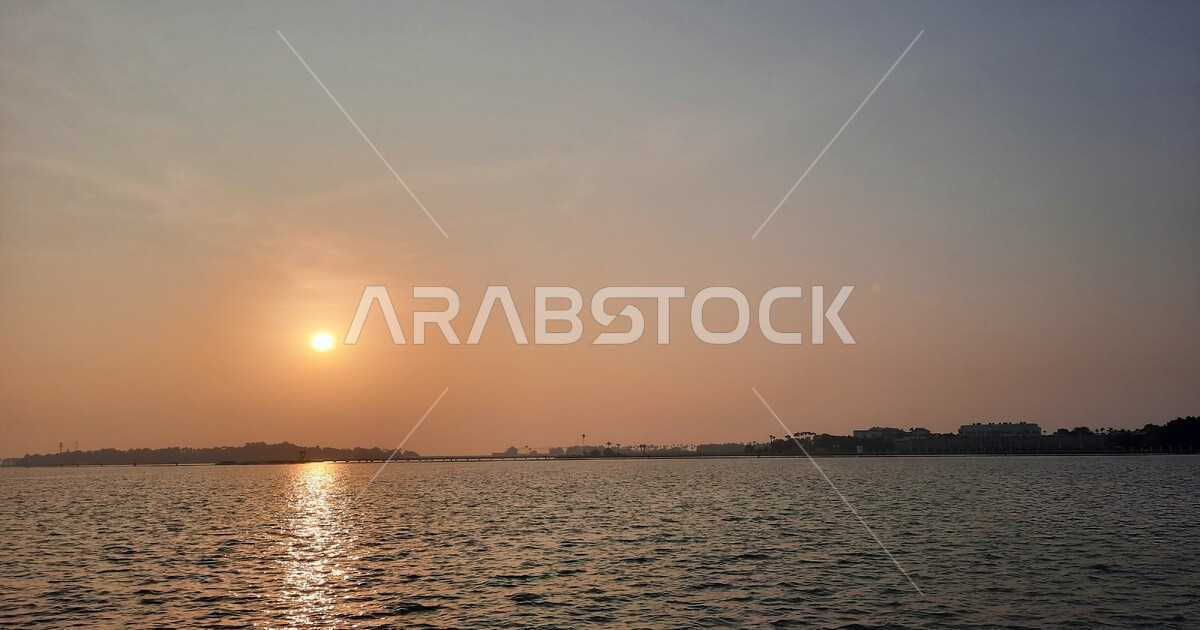 The view of the sun at sunset on the Jeddah Corniche, enjoying the calm ...