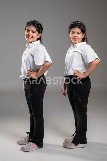 Standing straight with the hand on the waist and looking at the camera, wearing casual clothes ...