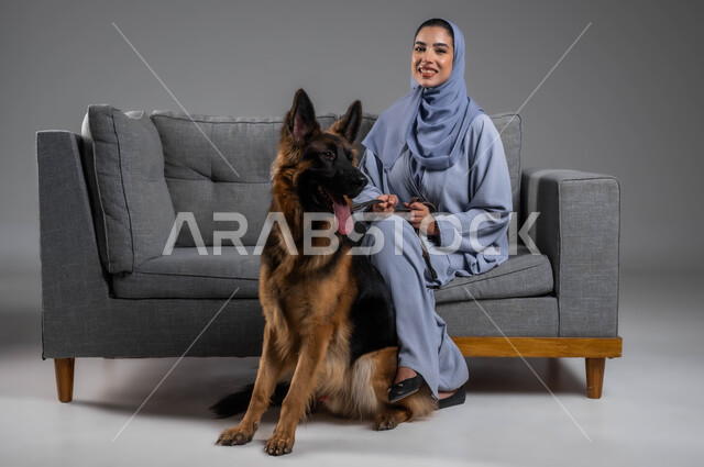 Fun and playing with pets, a portrait of a smiling Saudi Arabian Gulf ...