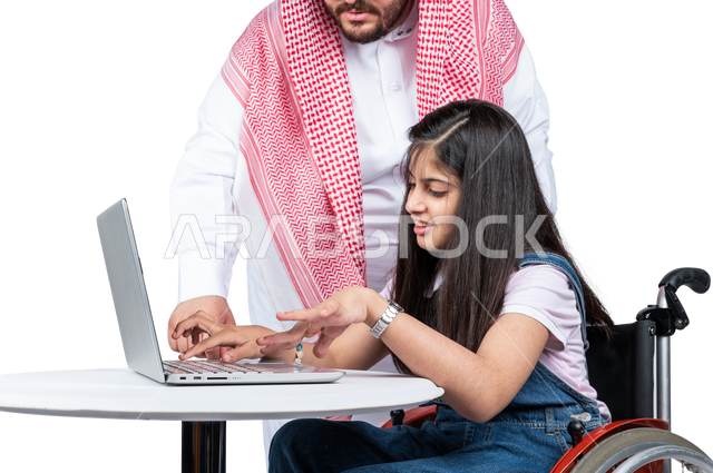 Portrait of a Saudi Arabian Gulf child in a wheelchair with her father ...