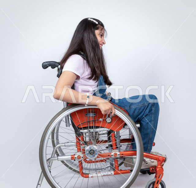 Portrait of a Saudi Arabian Gulf child in a wheelchair, different ...