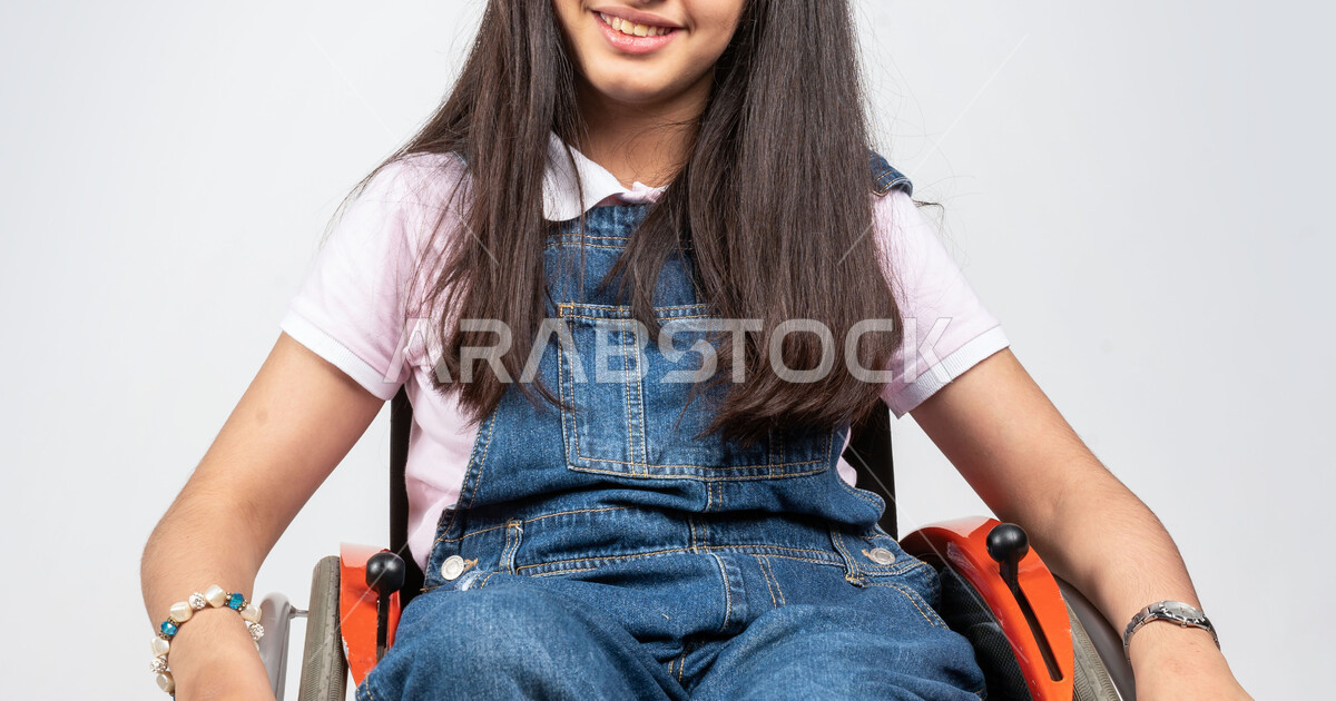 Portrait of a Saudi Arabian Gulf child in a wheelchair, different ...