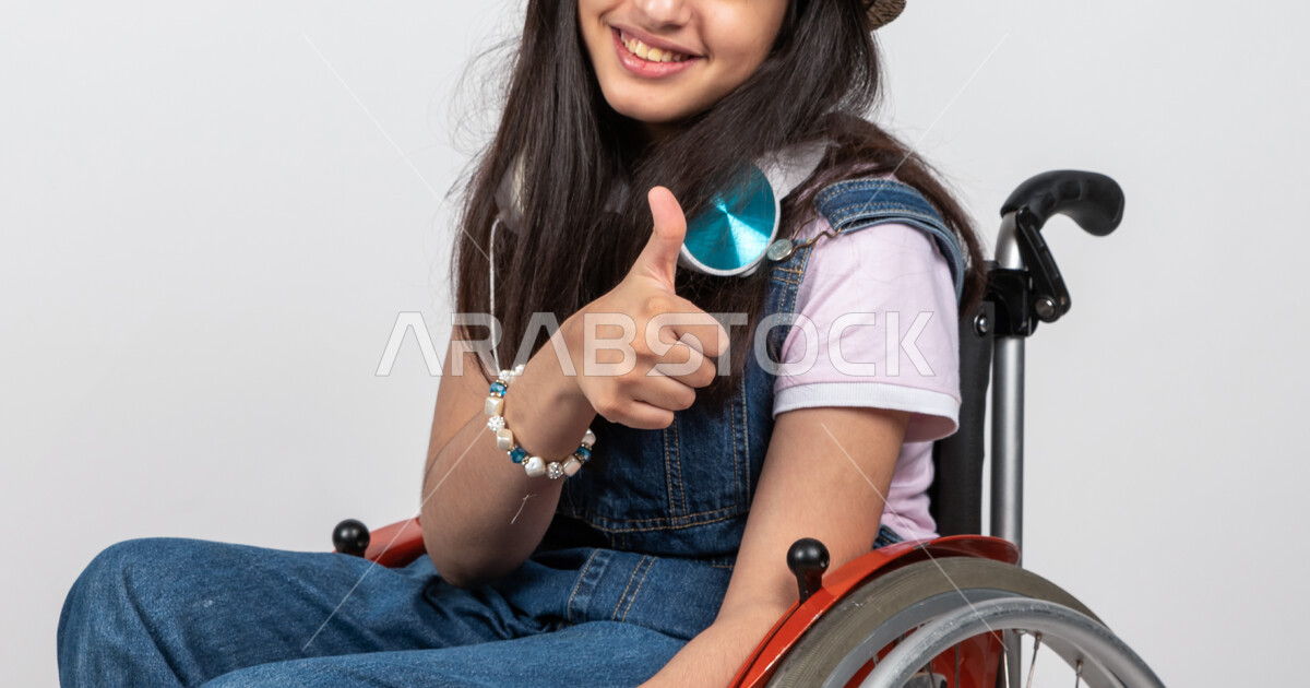 Portrait of a Saudi Arabian Gulf child in a wheelchair, different ...