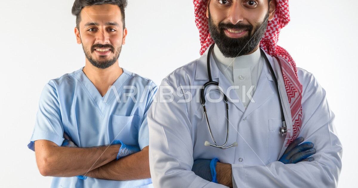 Portrait of two Saudi Arabian doctors smiling and looking at the camera ...
