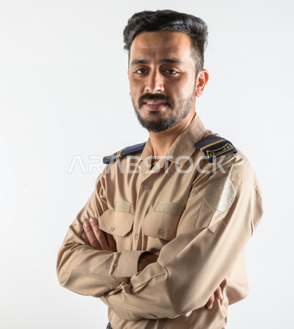 Portrait of a Saudi Arabian Gulf man working as a security man, wearing ...