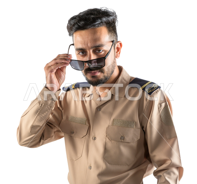 Portrait of a Saudi Arabian Gulf man working as a security man, wearing ...